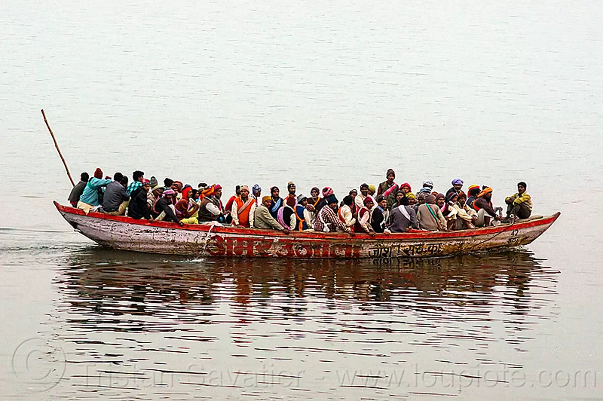 overcrowded river boat, india