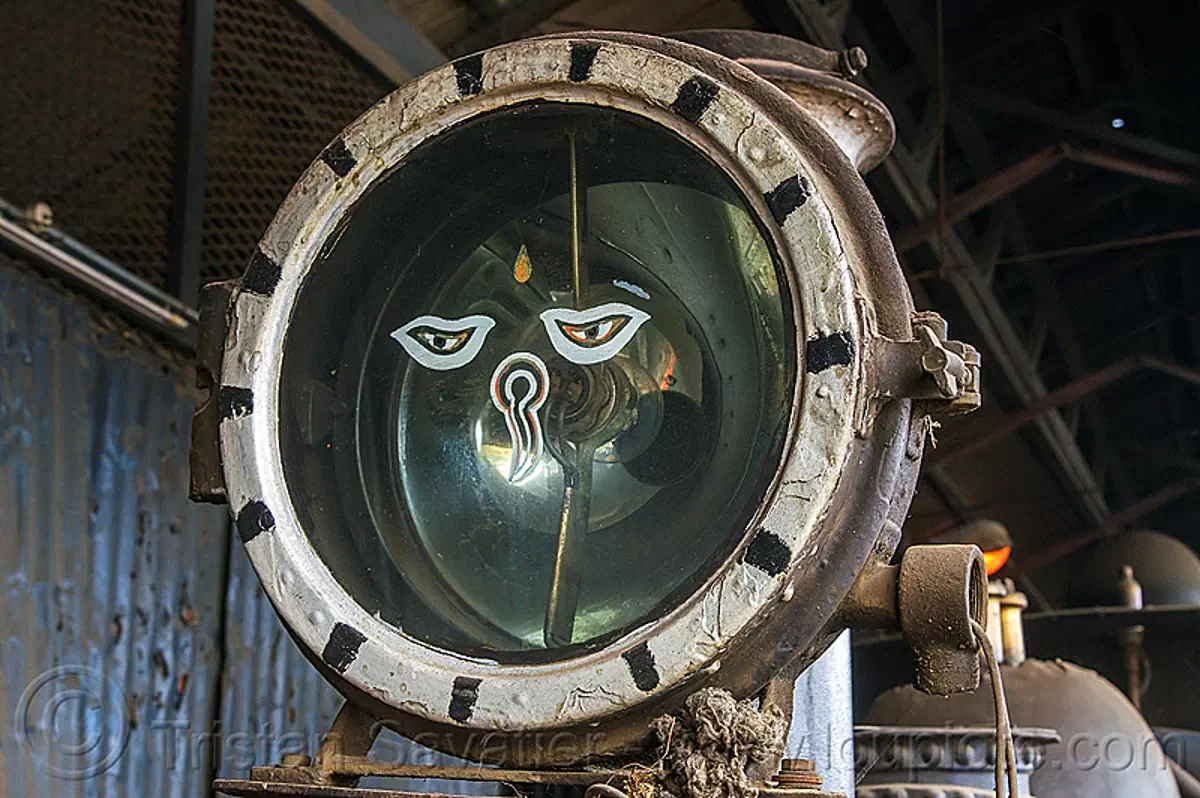 buddha eyes on headlight of steam locomotive, darjeeling, india
