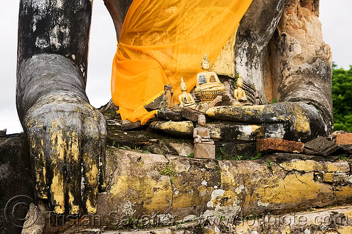 buddha statue in ruin of temple destroyed in the war, muang khoun, laos