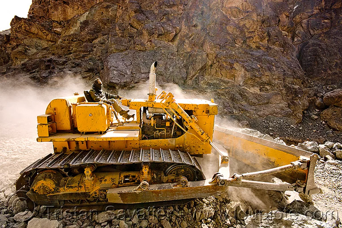 bulldozer clearing boulders, road construction, ladakh, india