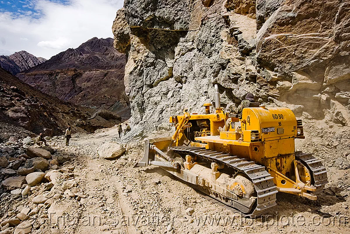 bulldozer clearing boulders, road construction, ladakh, india