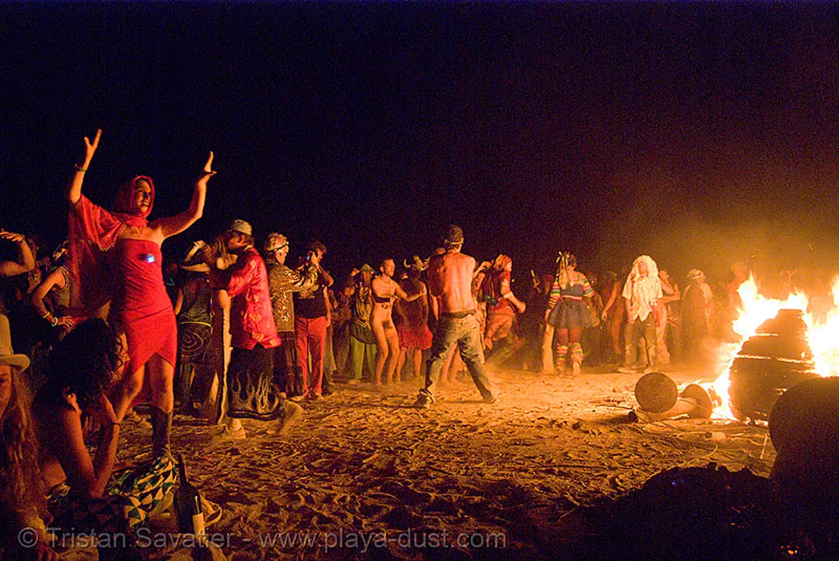 burning man, burners dancing around the fire