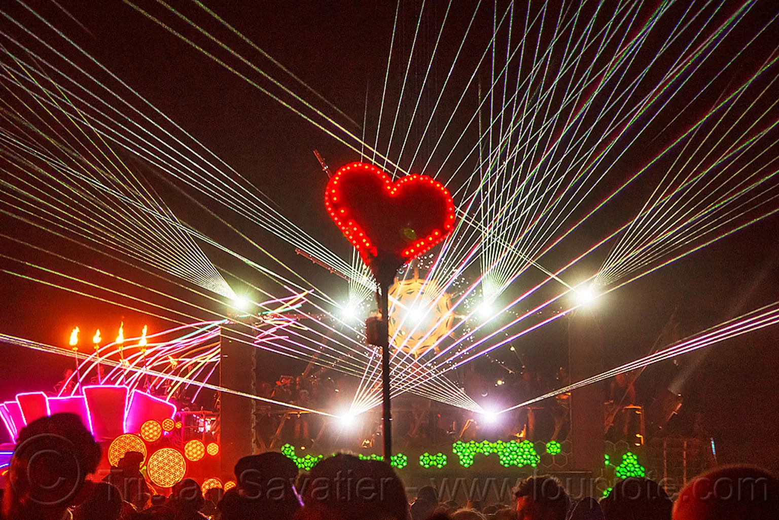 burning man, red heard on stick glowing in the night, white lasers