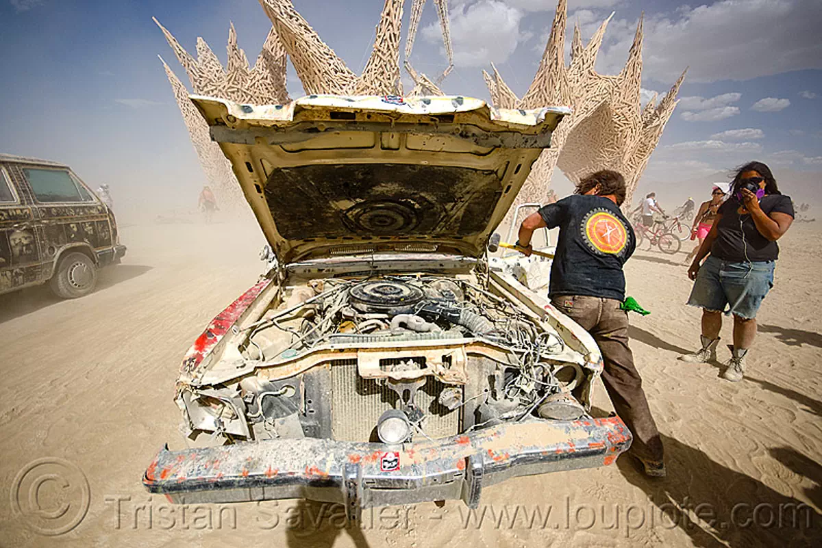 burning man, smashing a car