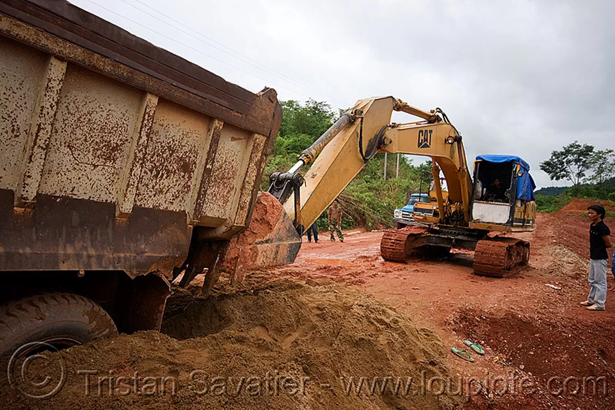 caterpillar CAT E200B excavator, truck getting a lift from an excavator ...