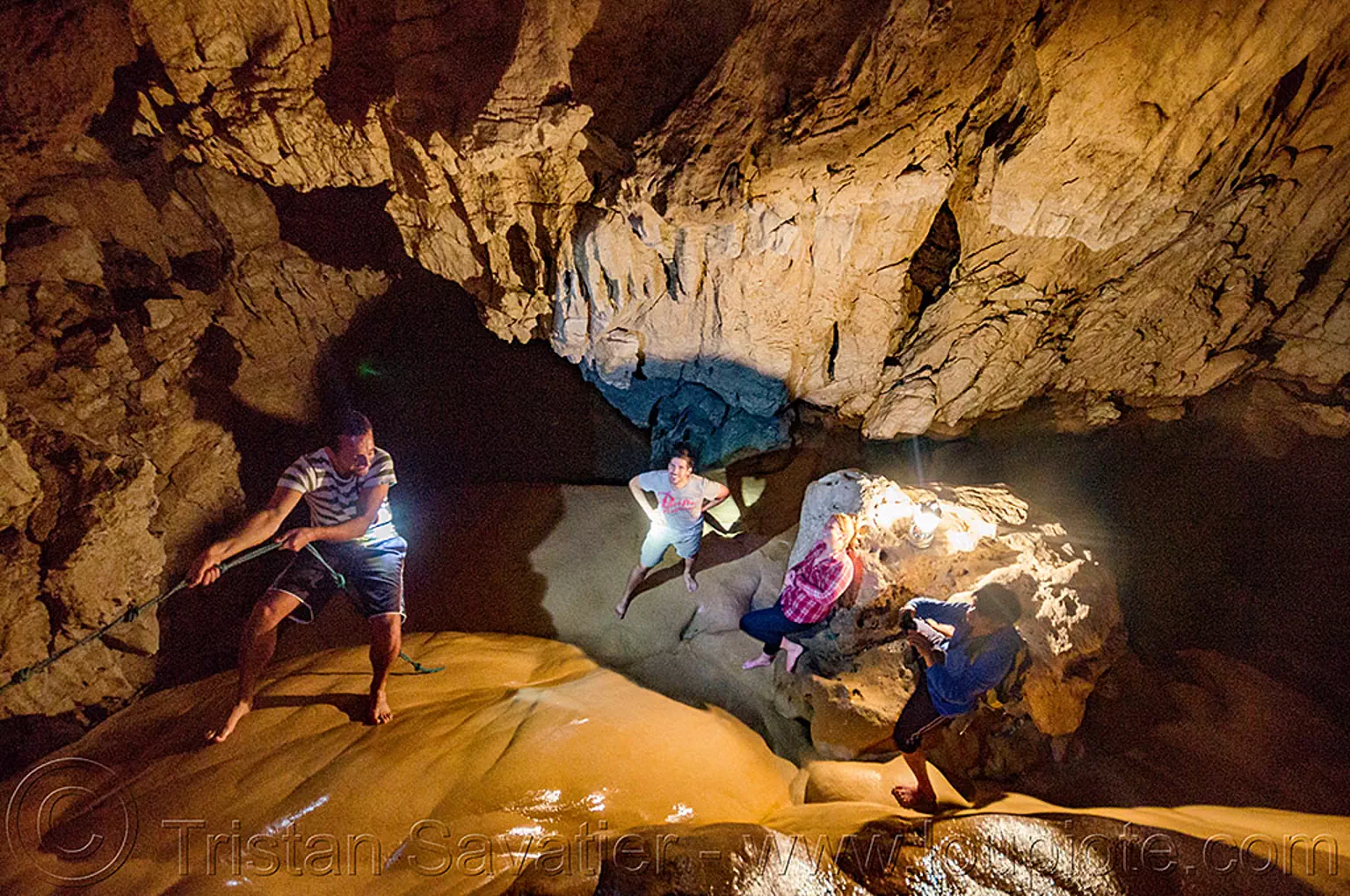 climbing a flowstone, sumaguing cave, sagada, philippines