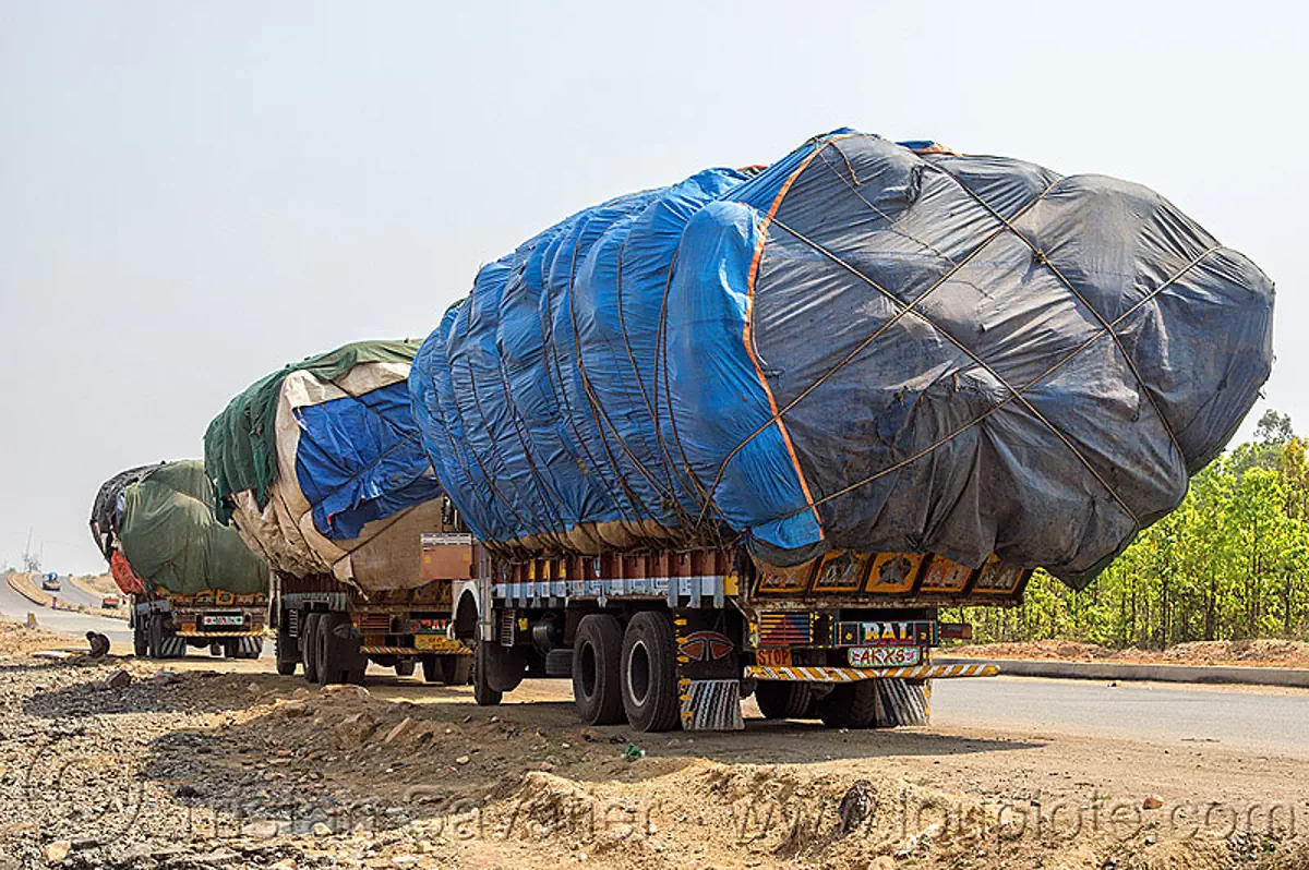 convoy of trucks with oversize loads, india