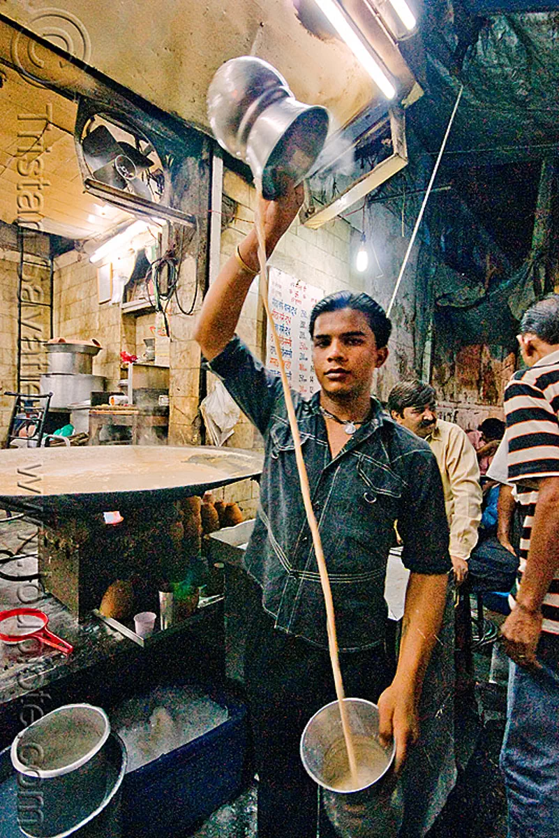 cooling the milk, cooked milk street vendor, delhi, india