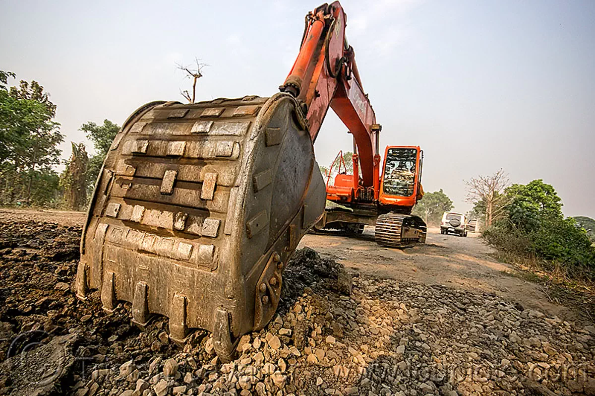 doosan excavator DX225LC scraping off old asphalt, india