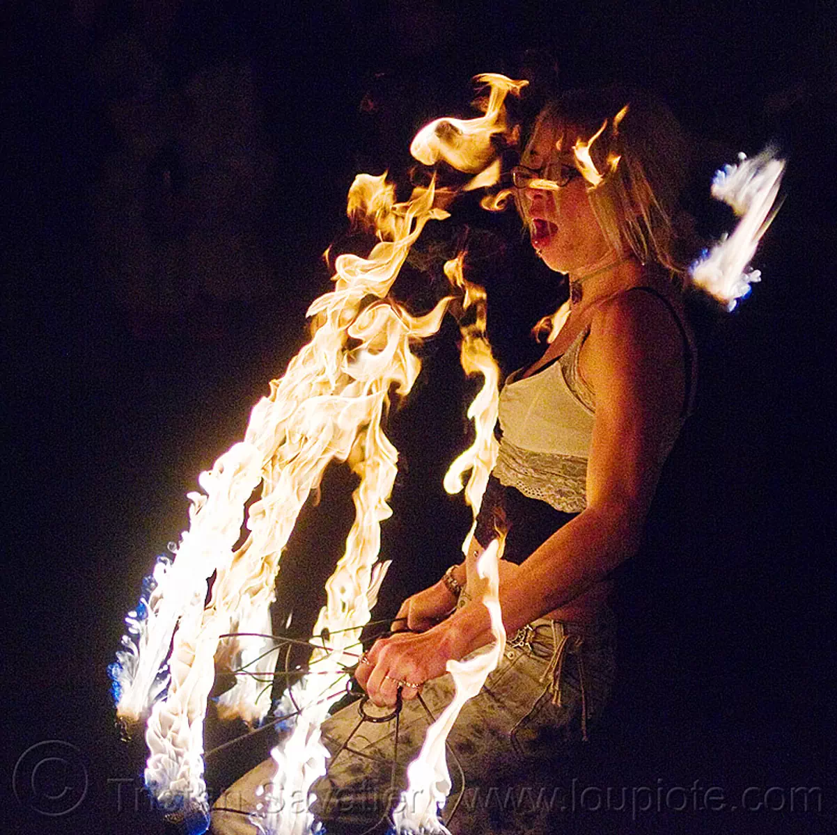 fire dancer with fire fans