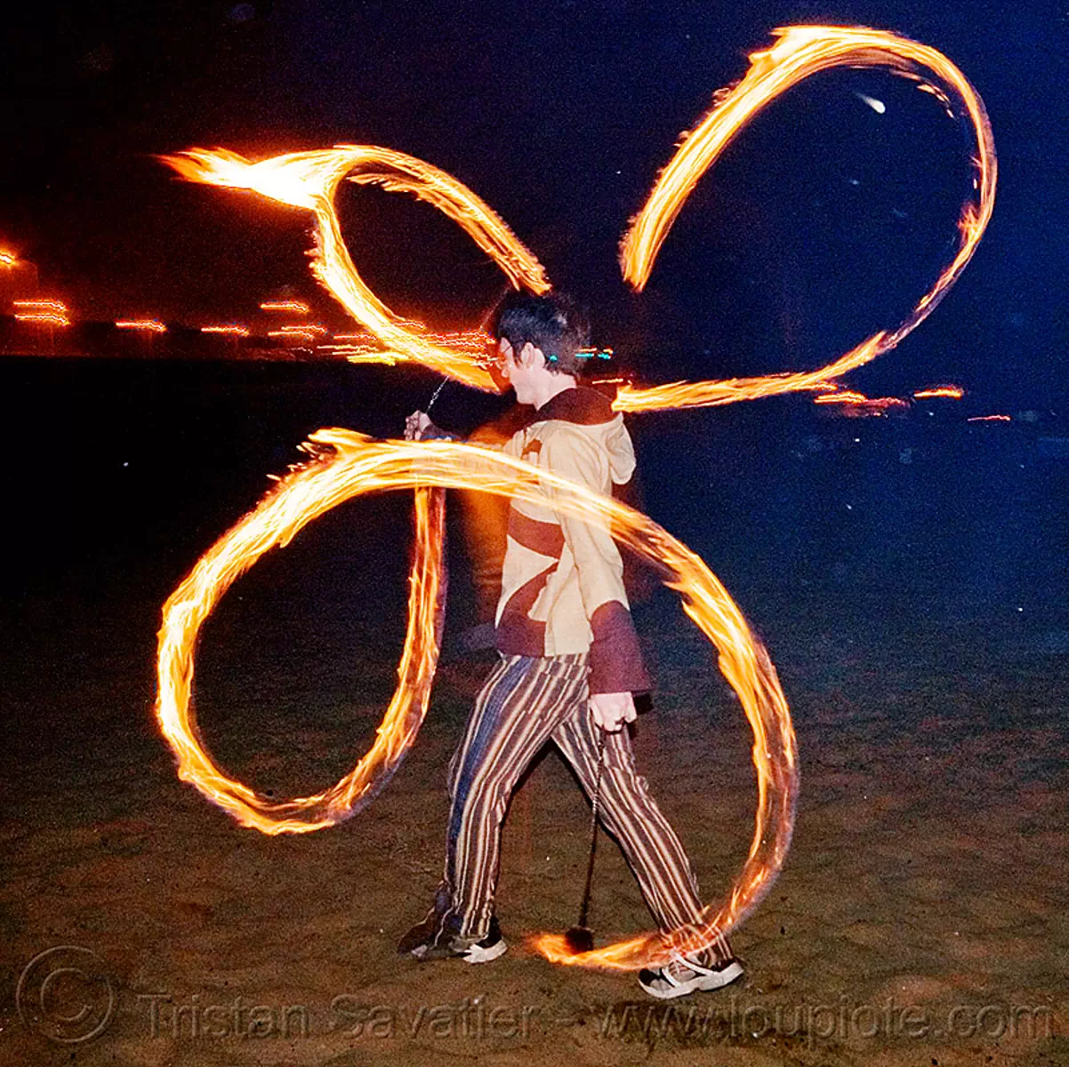 fire spinning on ocean beach, fire poi