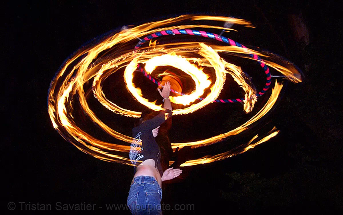 gina spinning a fire hula hoop, san francisco - #1049681519