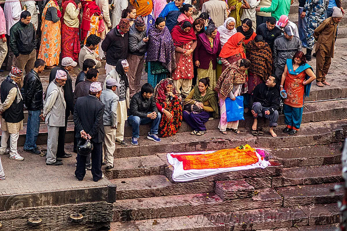 hindu funeral wake, corpse of the dead in shroud on ghat, nepal