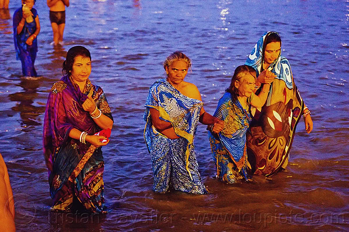 hindu women bathing in the ganges river at dawn