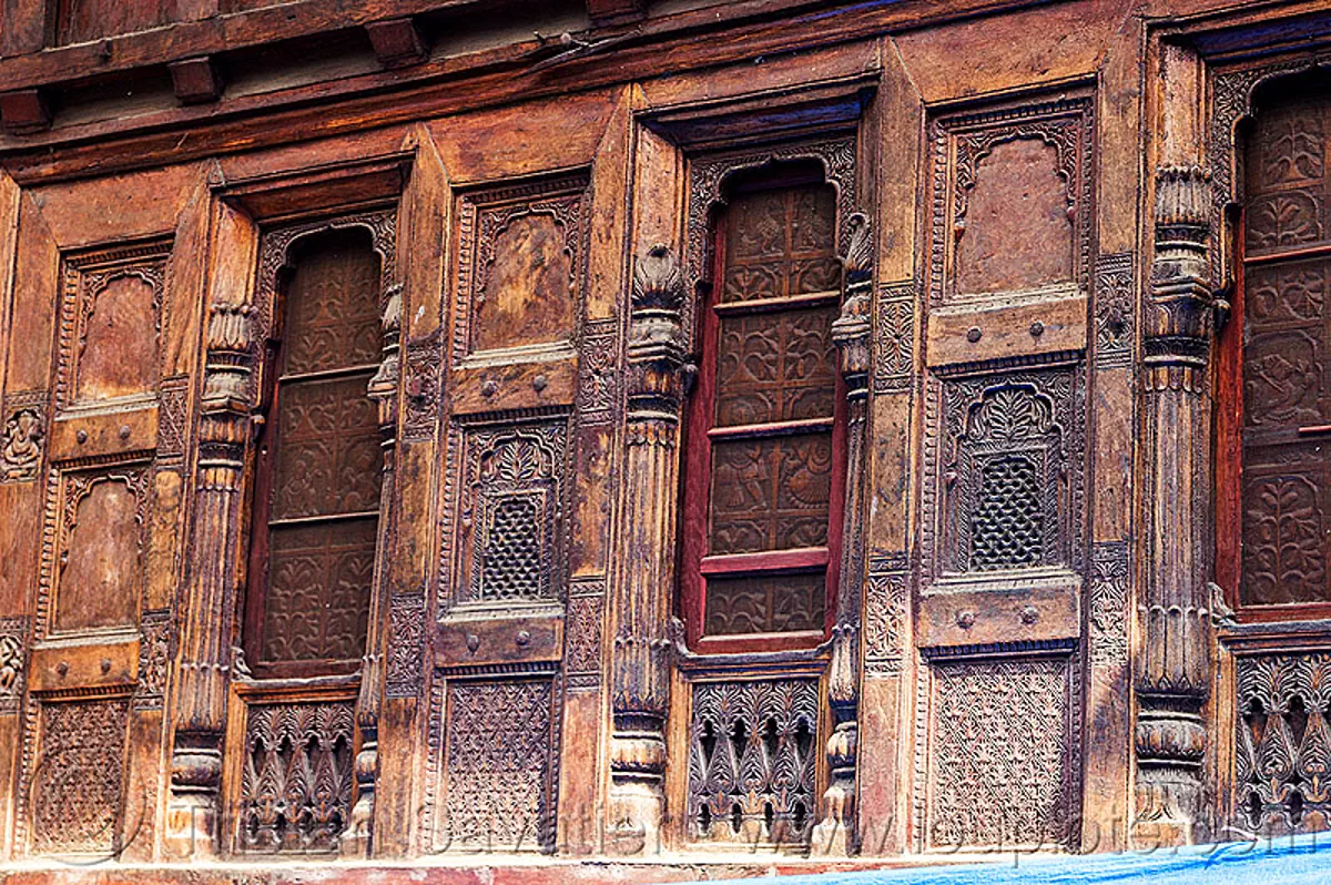 house facade with intricate wood carvings in almora, india