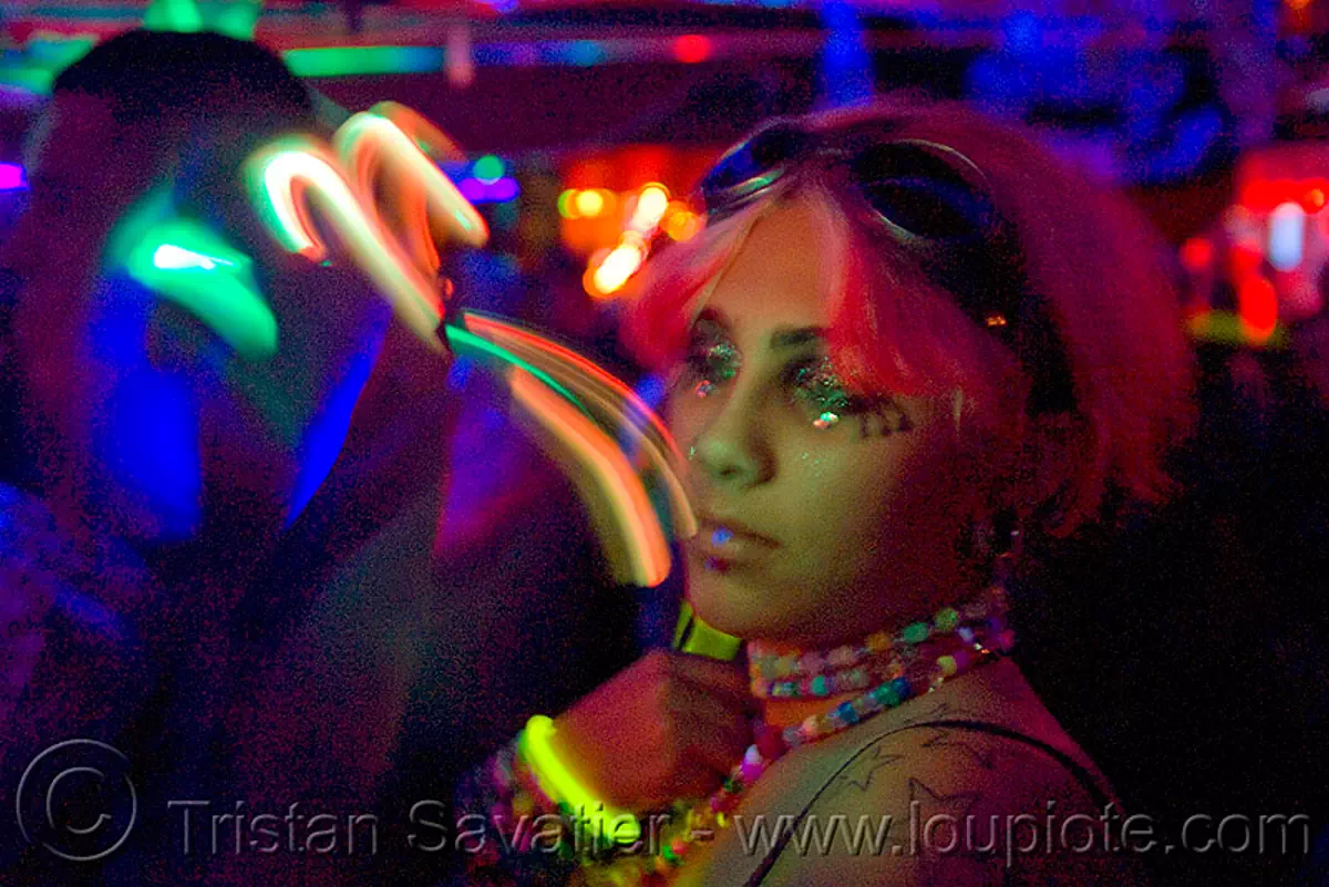 lightshow, young woman and moving LED lights in rave party