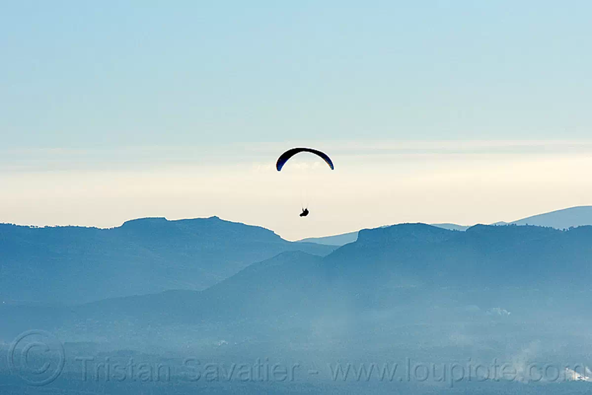 paragliding, paraglider flying in hazy sky