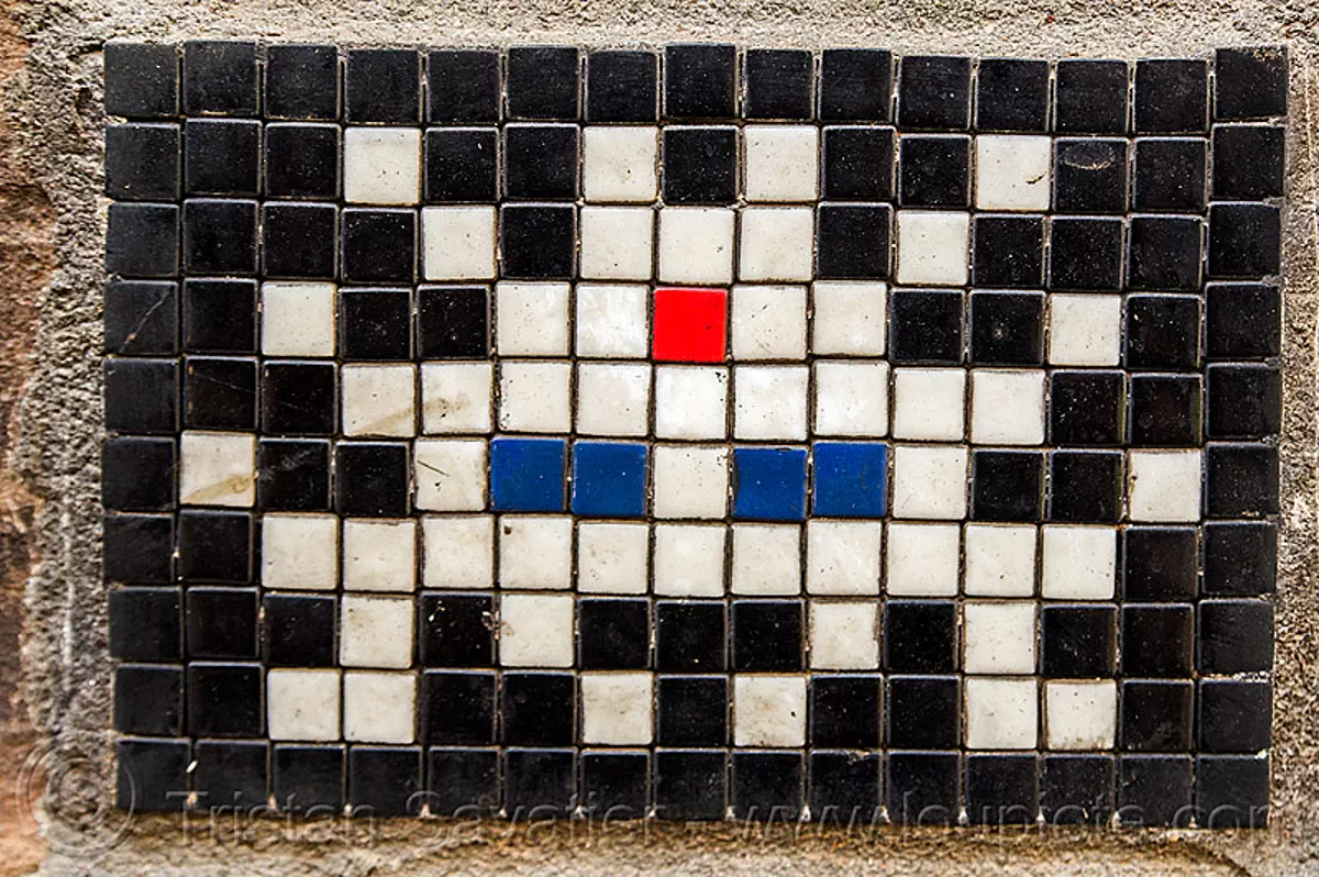 space invaders mosaic with red tilaka, india