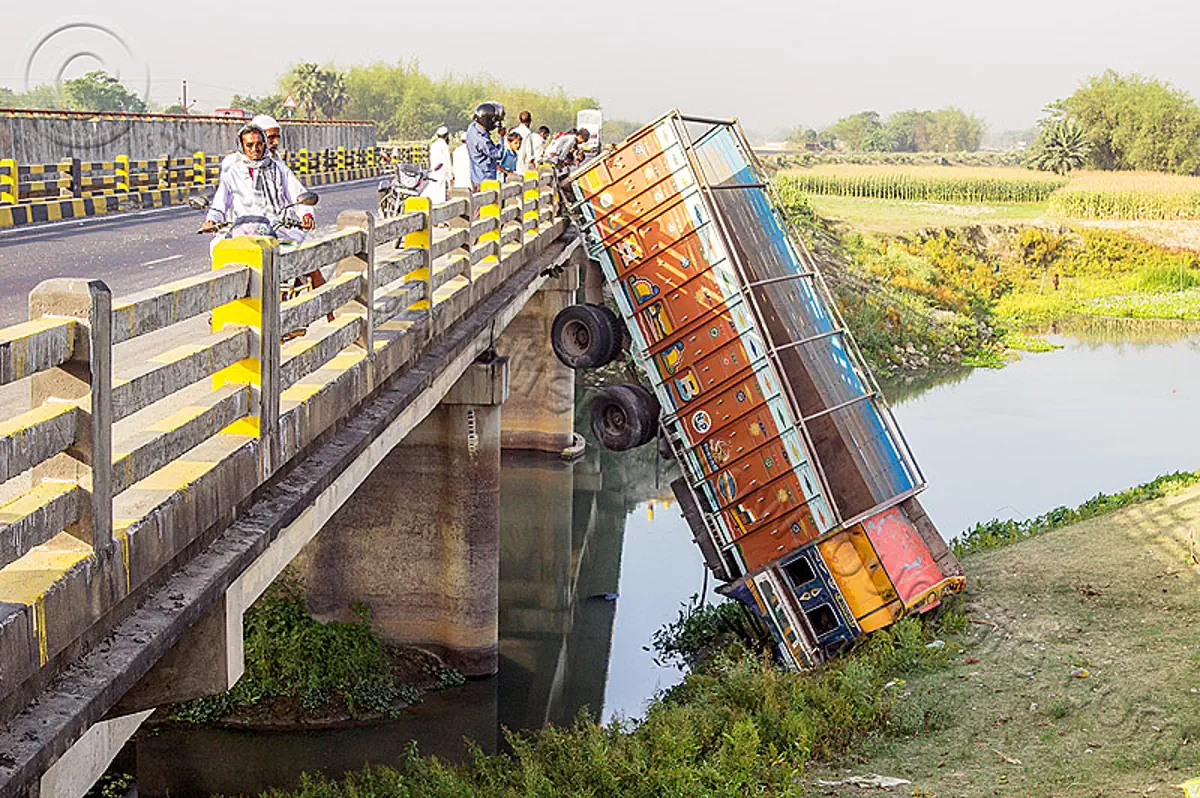 truck hanging off bridge, traffic accident, india