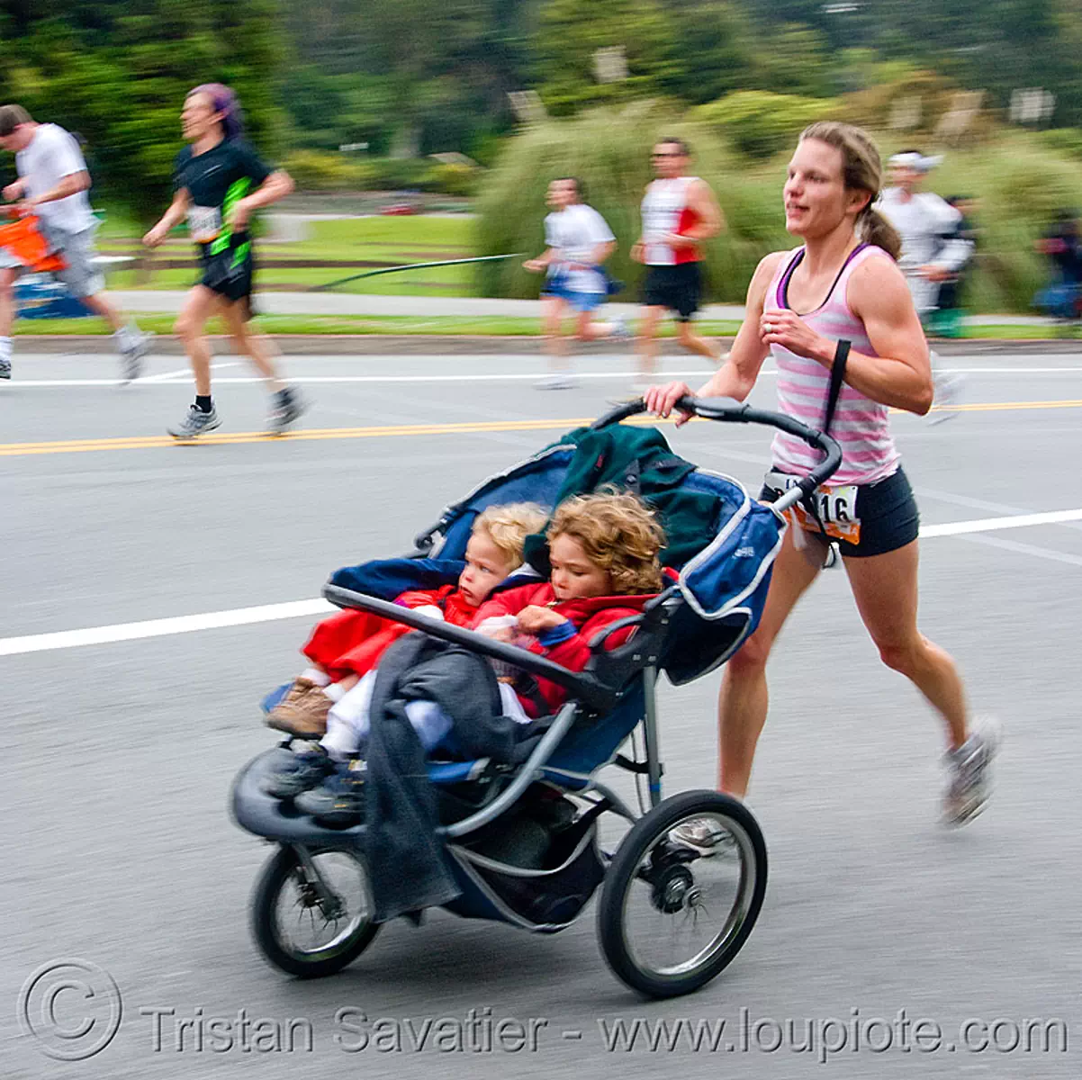 woman running with kids in a stroller
