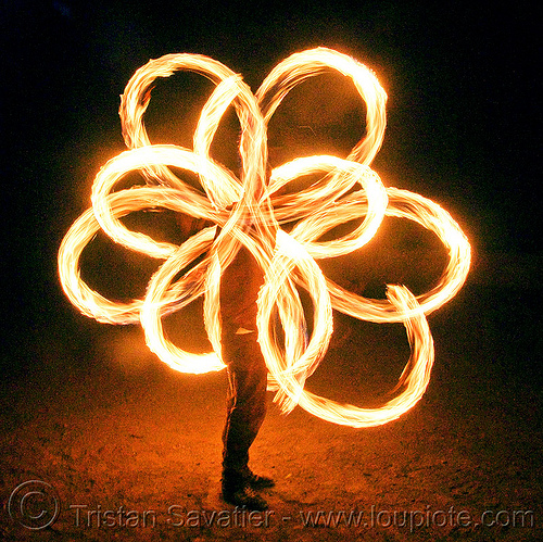 fire performer spinning fire poi
