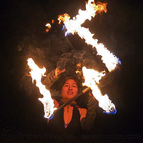 fire dancer "mel" with double fire staffs